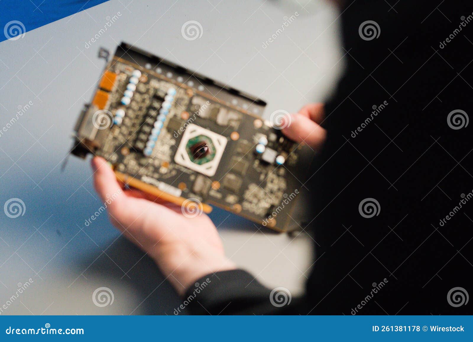 Hands Holding a Graphics Card GPU AMD with His Eye Reflected in the ...