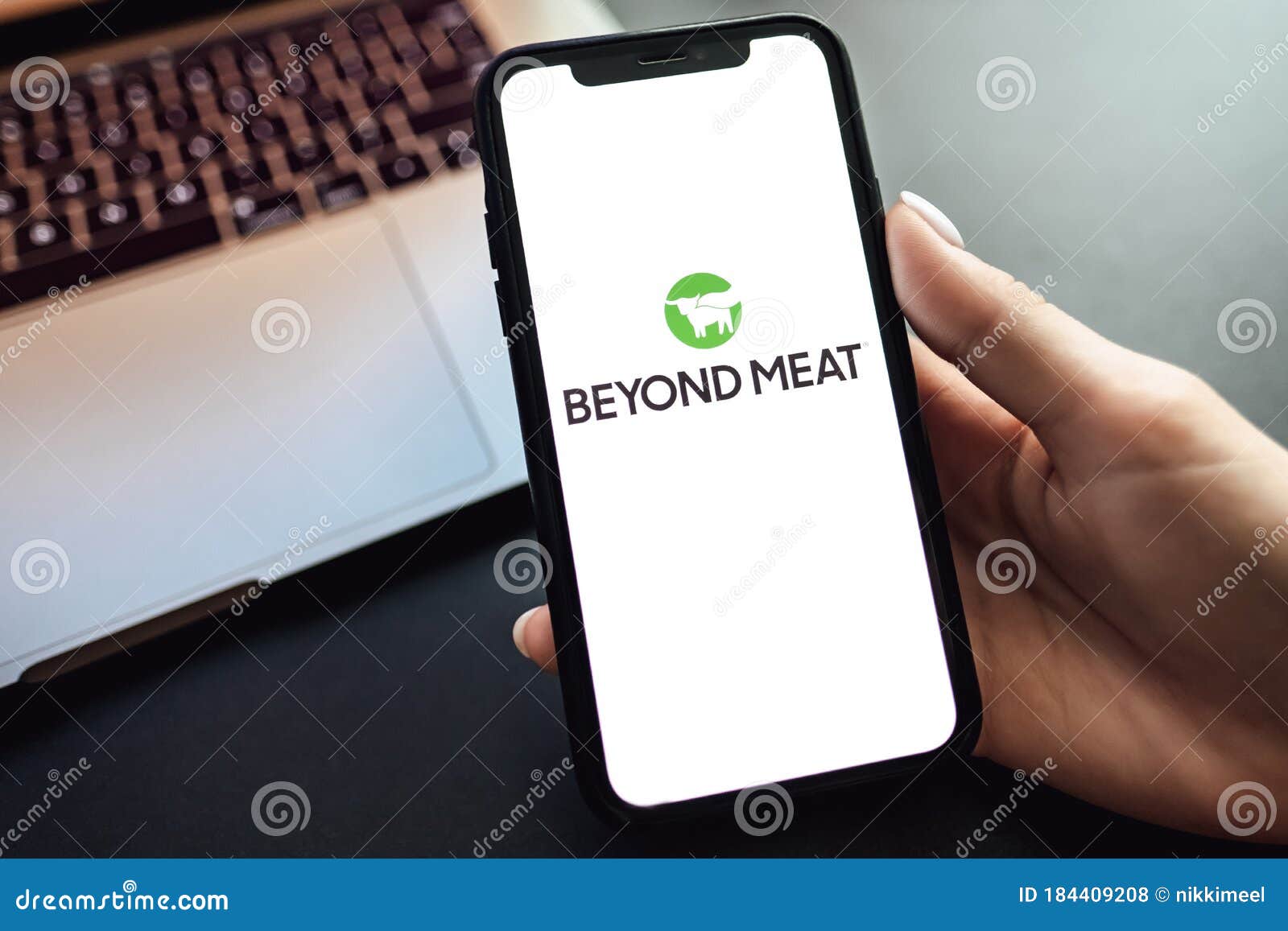Hands Holding IPhone X with Beyond Meat Logo on the Screen. Photo stock ...