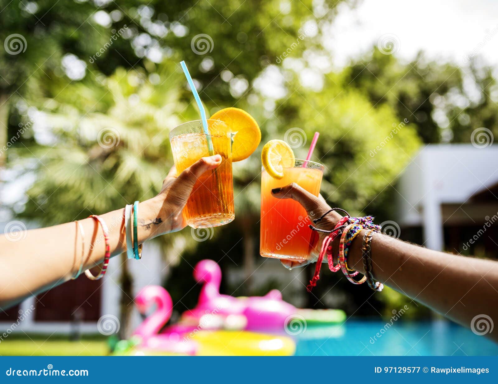 Hands Holding Juice Glasses by the Pool Summer Time Stock Image - Image ...