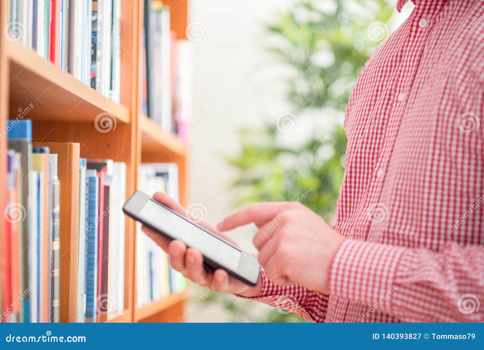 Hands Holding and Keeping Ebook on Bookshelf Background Stock Image ...