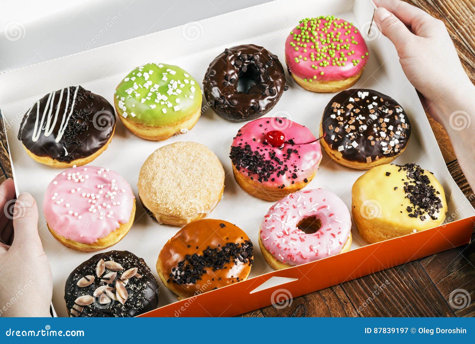 Hands Holding an Open Box of Assorted Donuts Stock Image - Image of ...