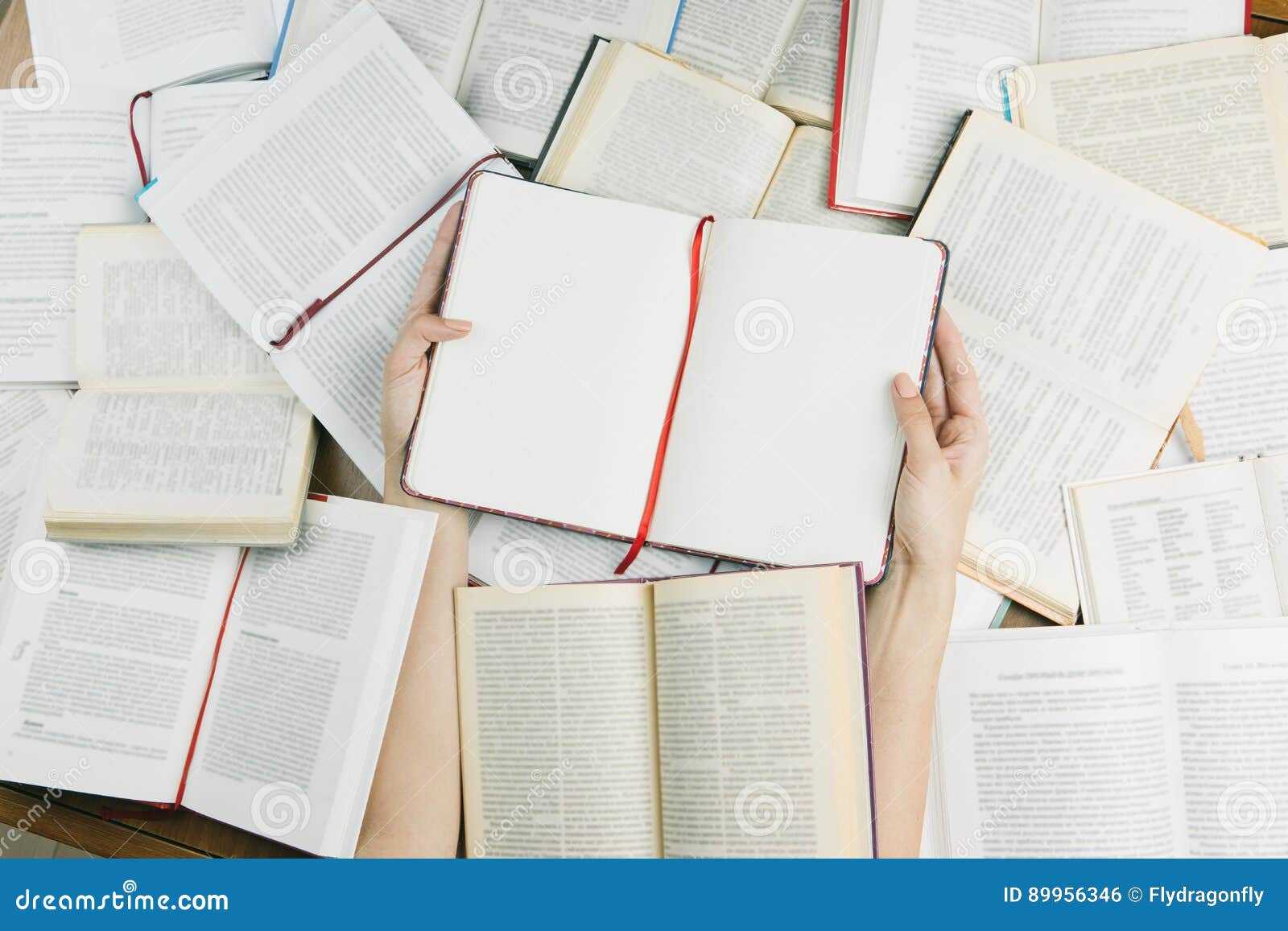 Hands Holding Opened Notebook among Many Books. Stock Photo - Image of ...