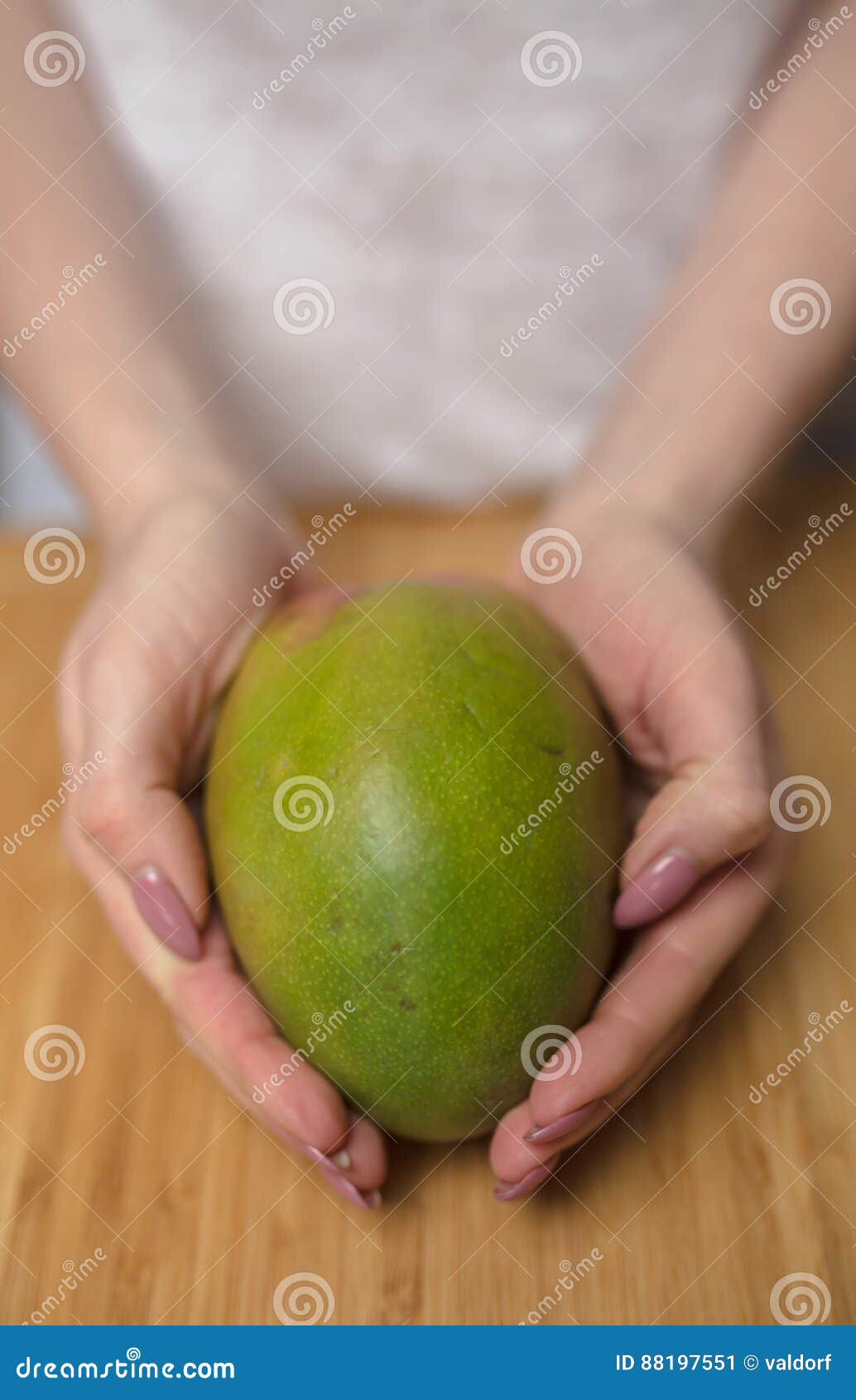 Hands Holding Ripe Mango at Table Stock Image - Image of female, fruit ...