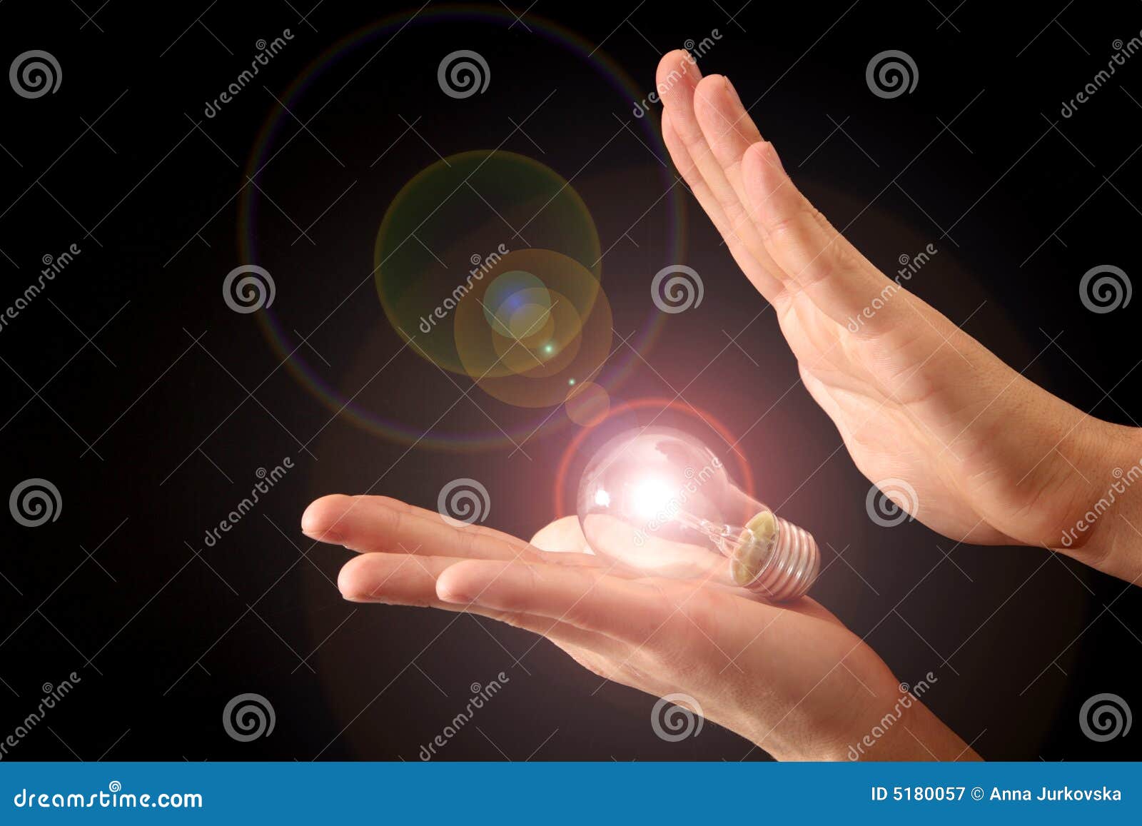 Hands holding shining lamp stock image. Image of isolated - 5180057