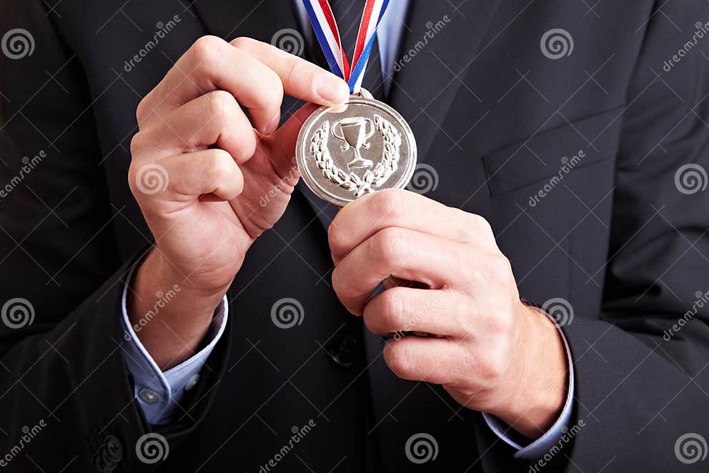 Hands holding silver medal stock image. Image of hand - 18456883