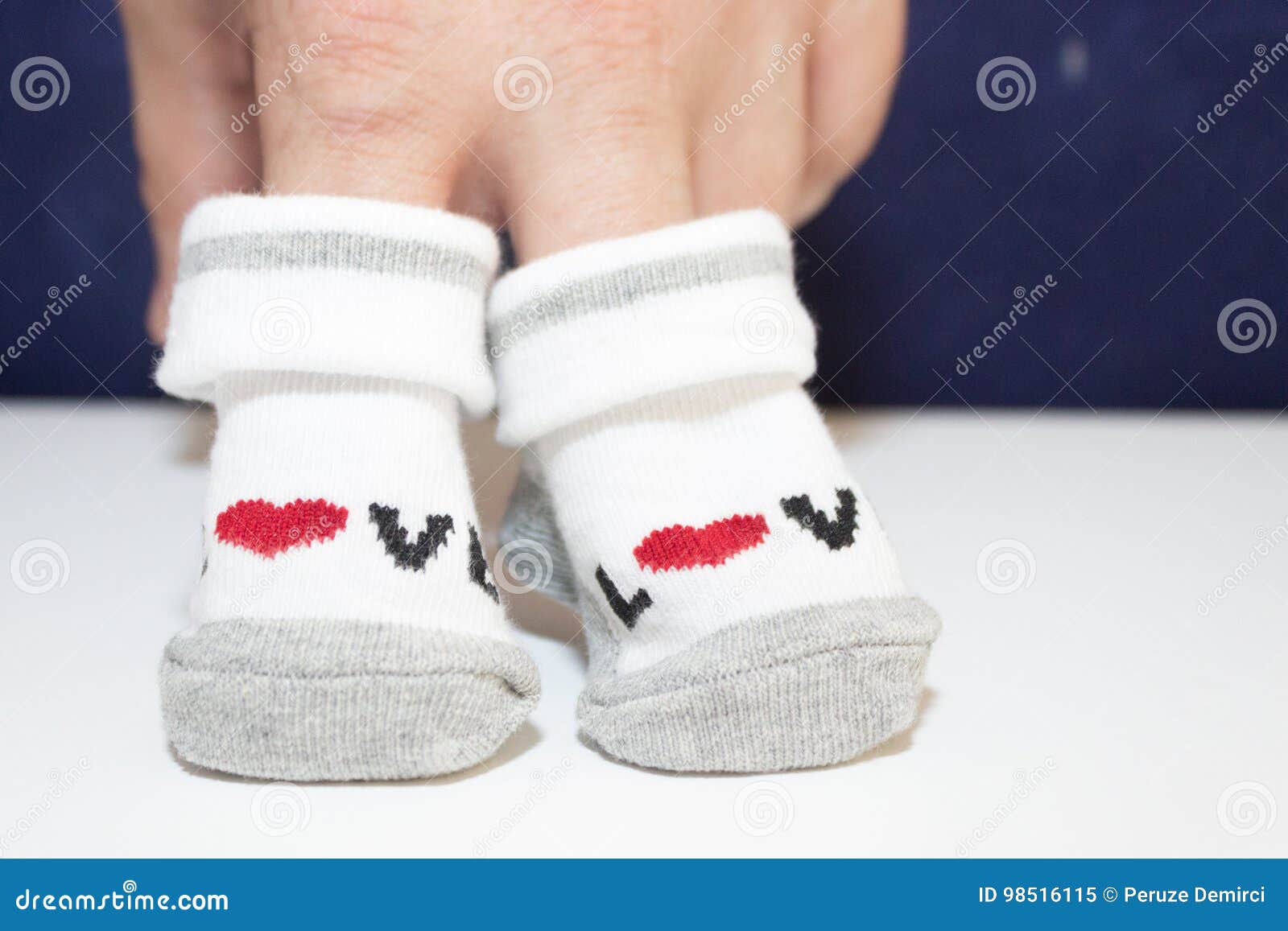 Hands Holding Small Baby Socks Stock Image - Image of closeup, arms ...