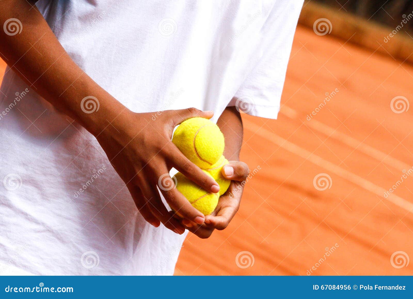 Hands holding tennis balls stock photo. Image of concept - 67084956