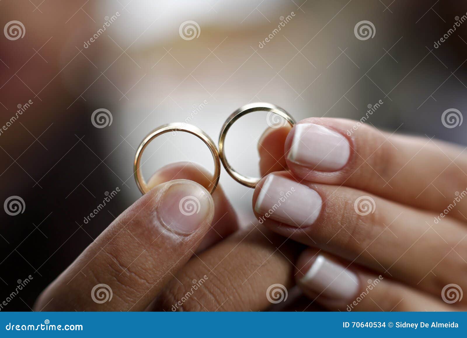 Hands Holding Wedding Rings Stock Photo - Image of detail, love: 70640534