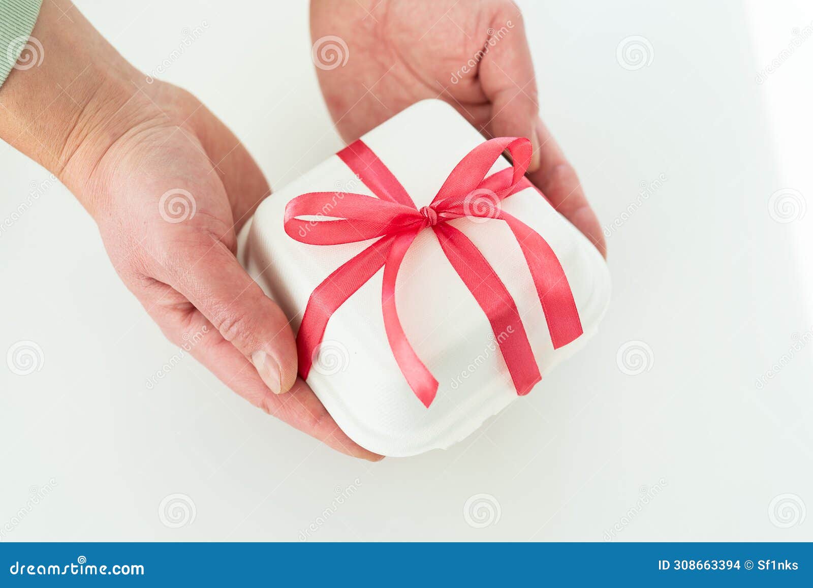 Hands Holding a White Box with a Red Ribbon and a Bento Cake Inside on ...