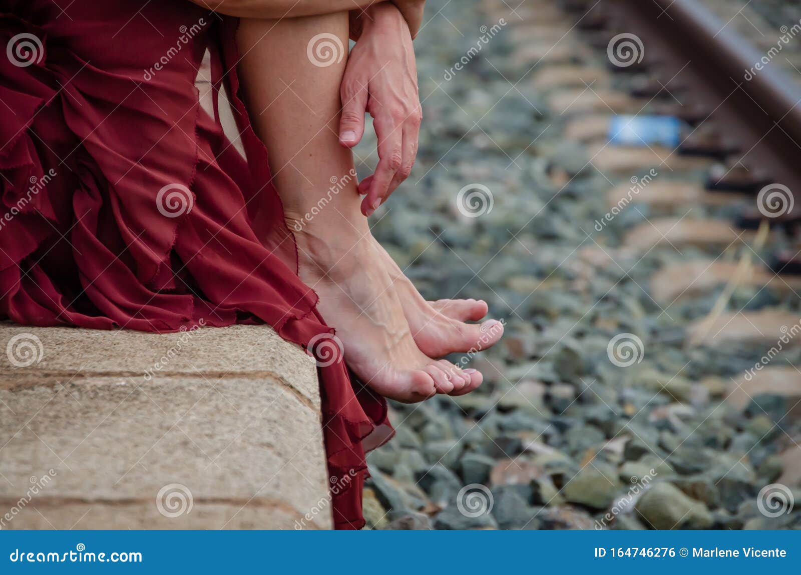Hands Hugging a Woman& X27;s Legs on the Train Track Stock Photo ...
