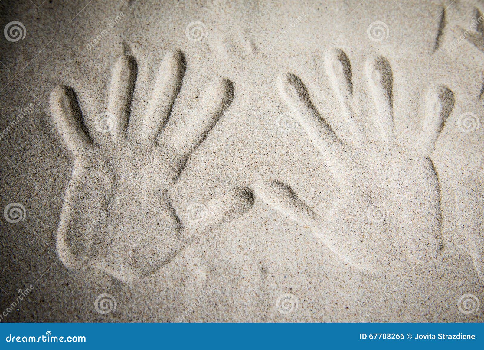 Hands imprints in the sand stock photo. Image of background - 67708266