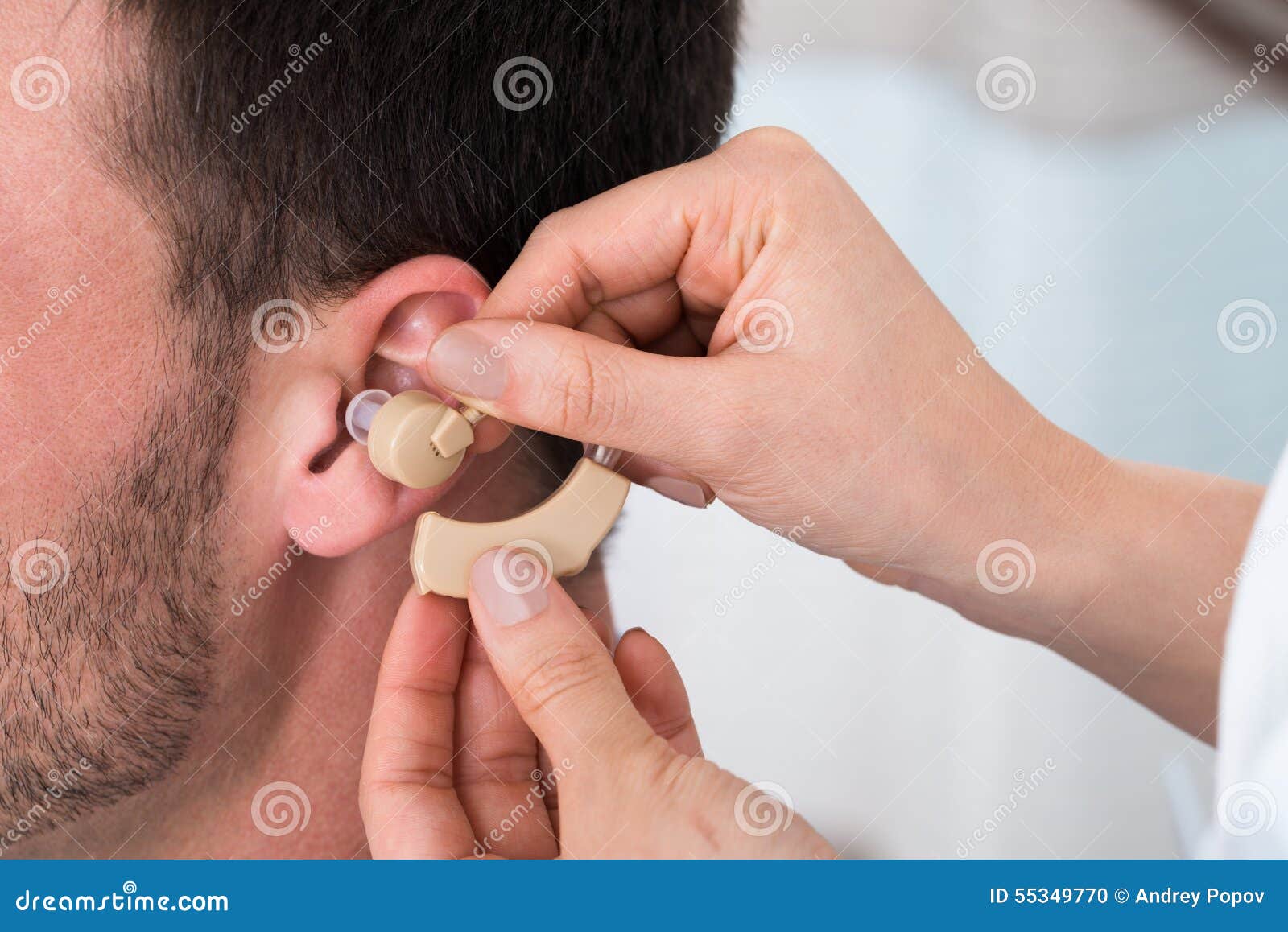 Hands Inserting a Hearing Aid into a Man S Ear Stock Photo - Image of ...