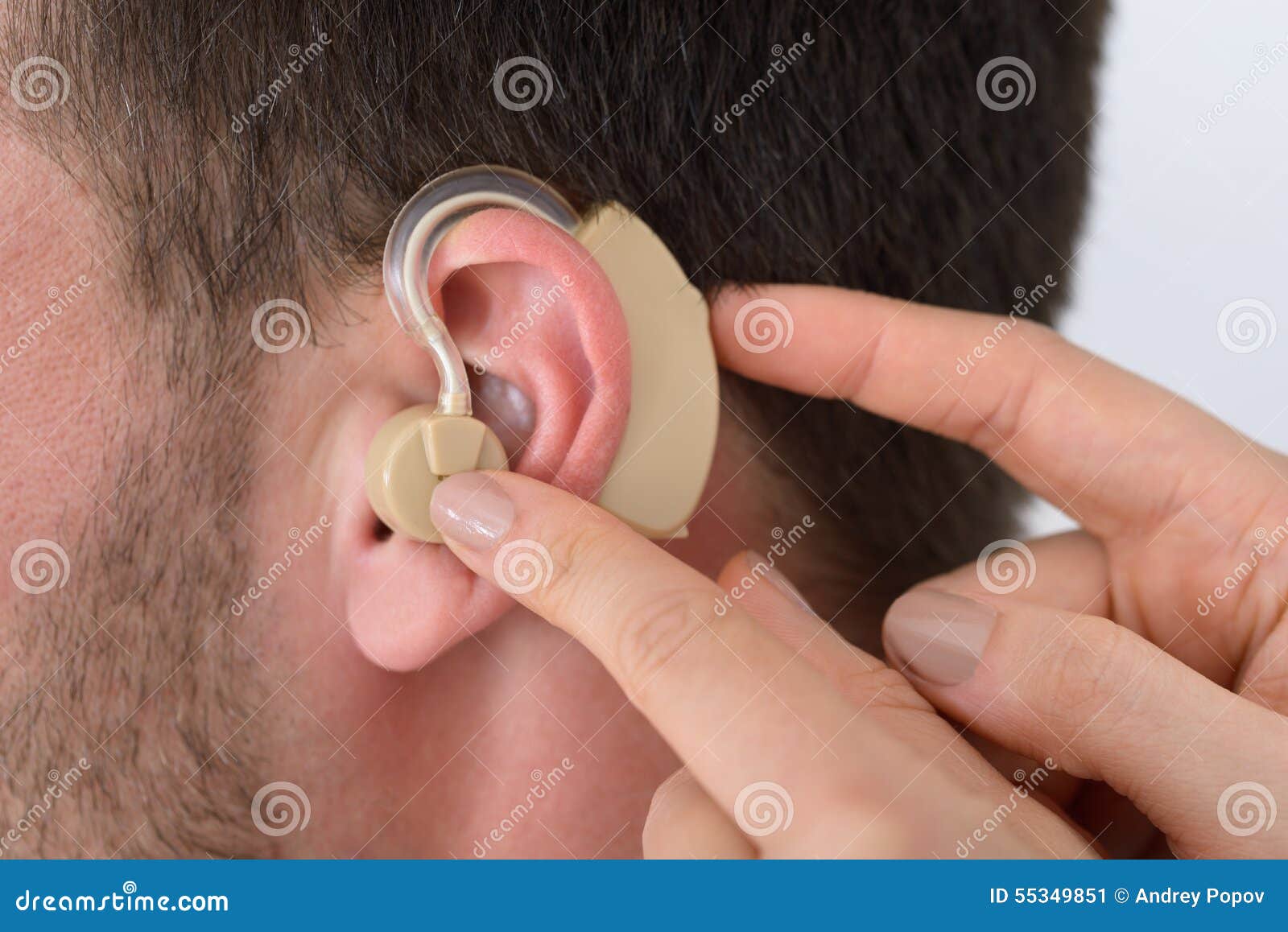 Hands Inserting a Hearing Aid into a Man S Ear Stock Image - Image of ...