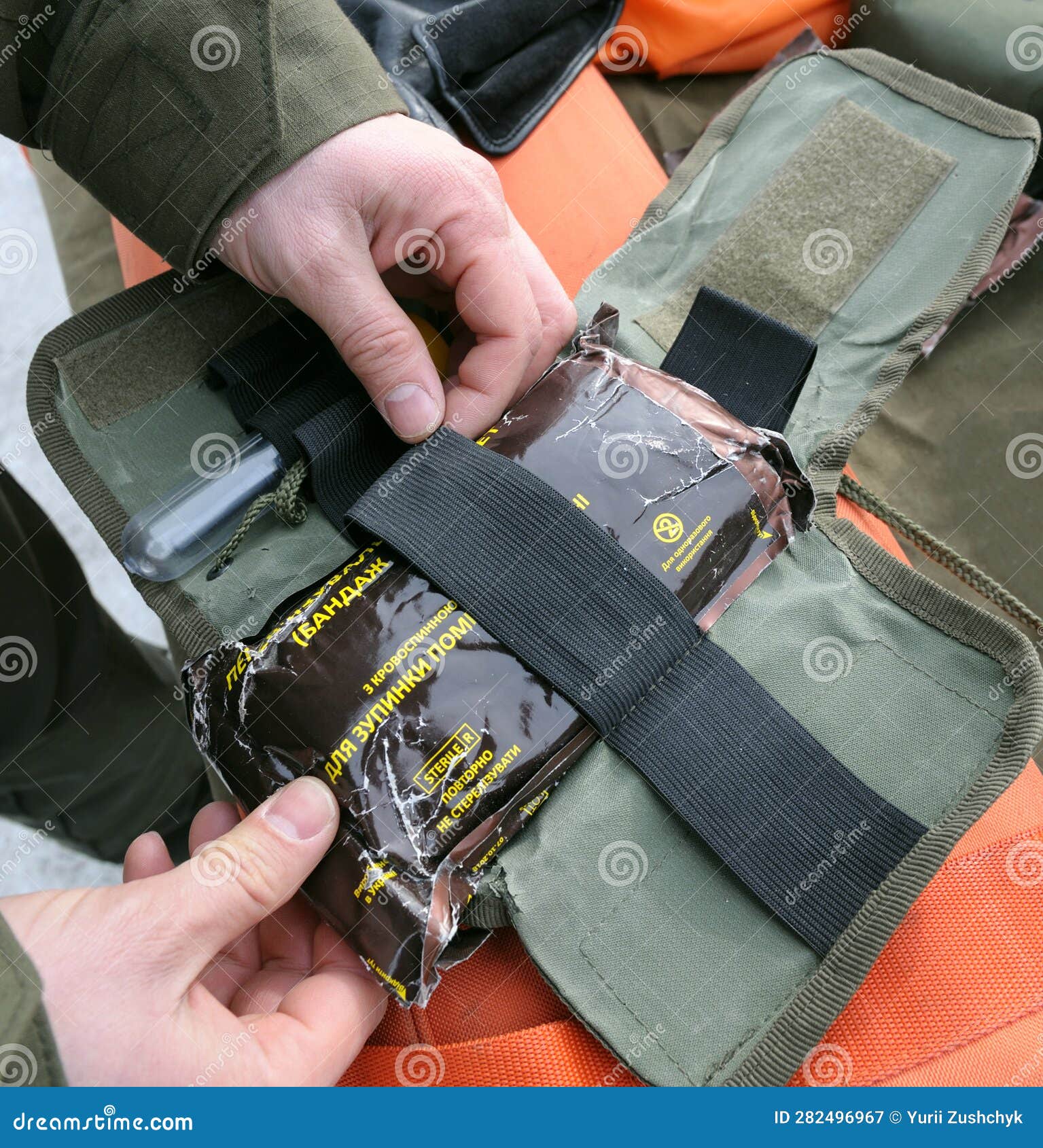 Hands of Instructing Officer Holding First-aid Kit Pack Showing Its ...
