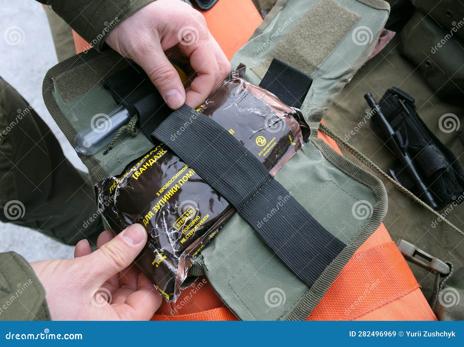 Hands of Instructing Officer Holding First-aid Kit Pack Showing Its ...