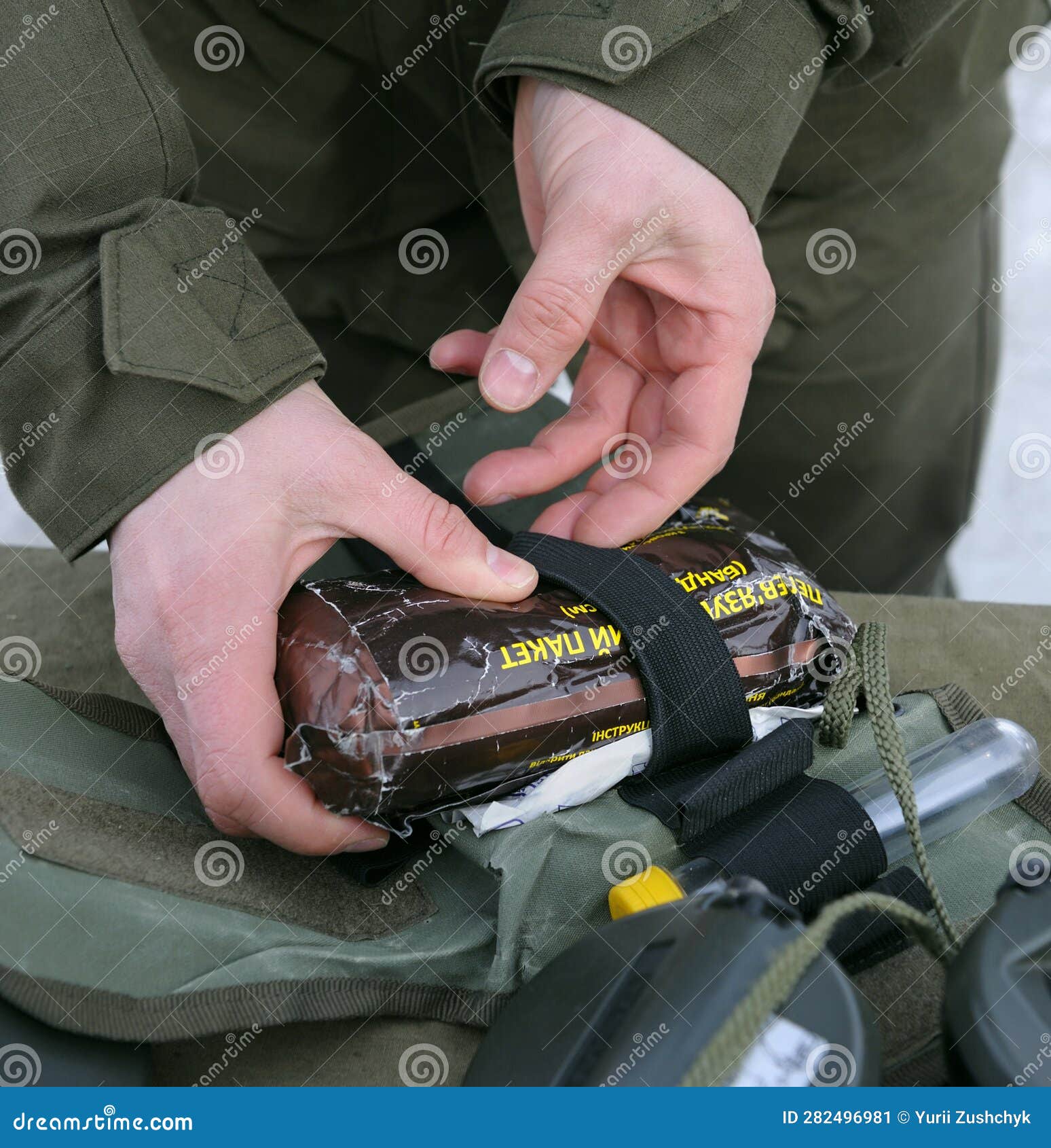 Hands of Instructing Officer Holding First-aid Kit Pack Showing Its ...