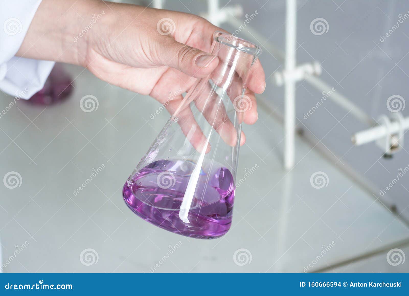 In the Hands of the Laboratory Assistant is a Flask with a Purple ...