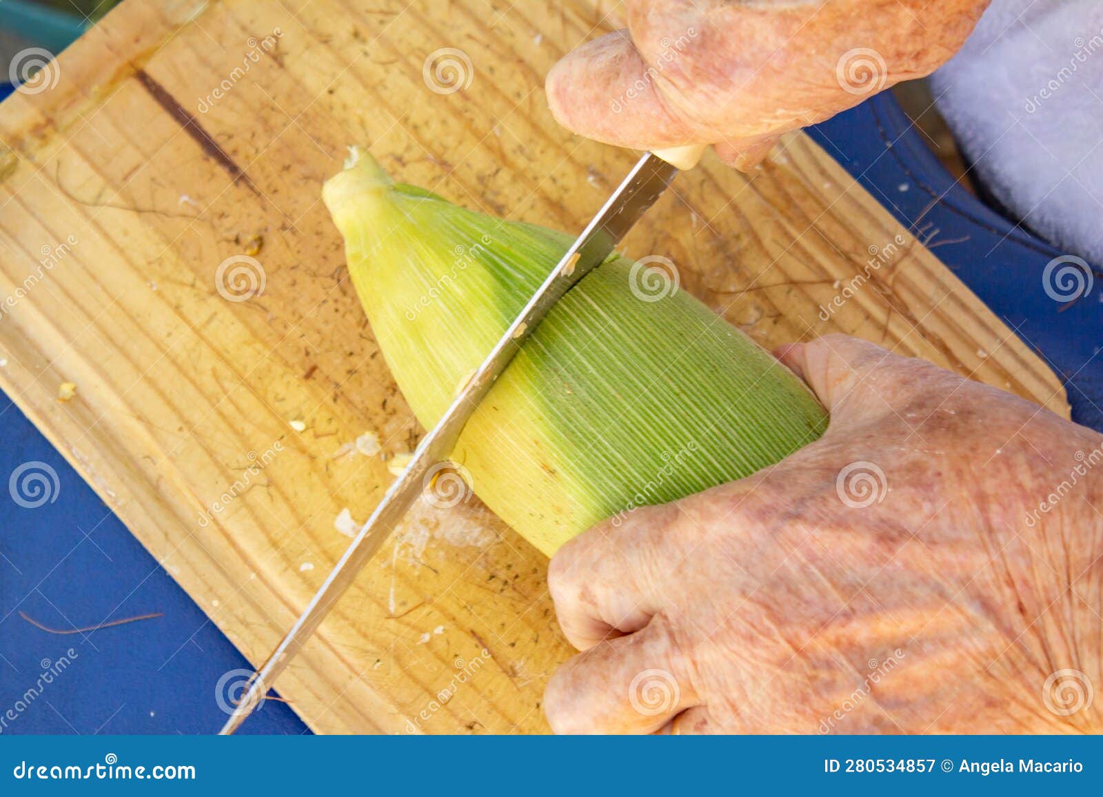 Hands of a Lady Cutting the Tip of the Corn Cob. Stock Image - Image of ...