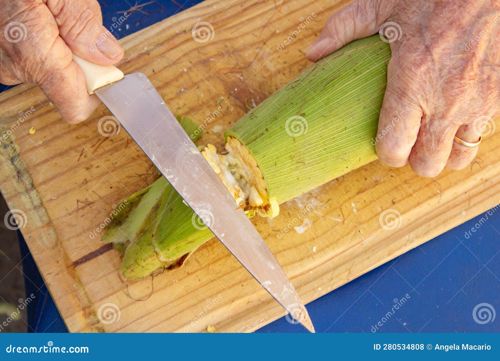 Hands of a Lady Cutting the Tip of the Corn Cob. Stock Photo - Image of ...