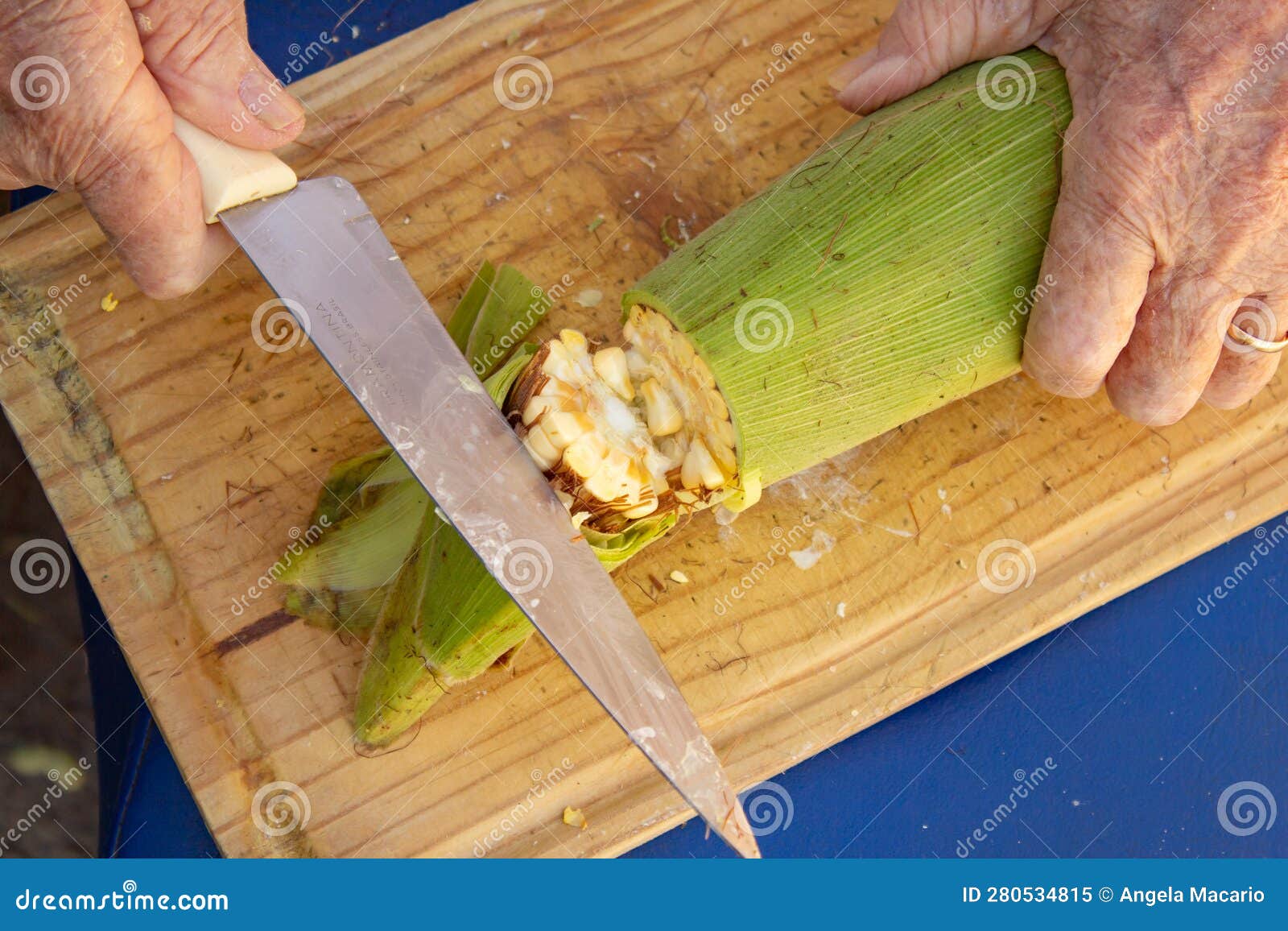 Hands of a Lady Cutting the Tip of the Corn Cob. Stock Image - Image of ...