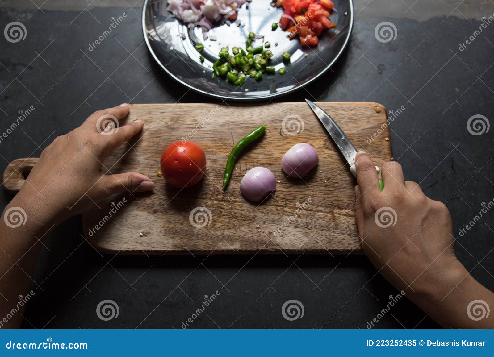 Hands of a Lady Holding a Knife Preparing To Chop Vegetables Stock ...