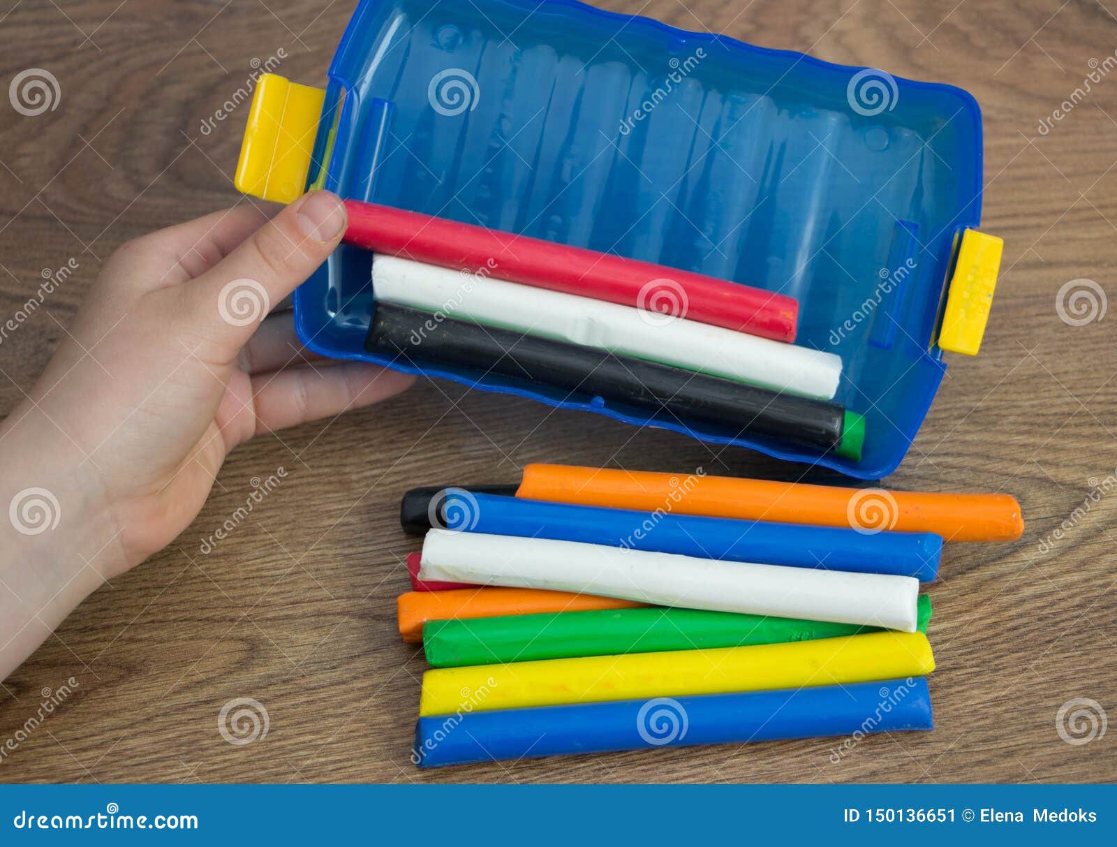 The Hands of the Little Girl Take Out the Multi-colored Clay Stock ...