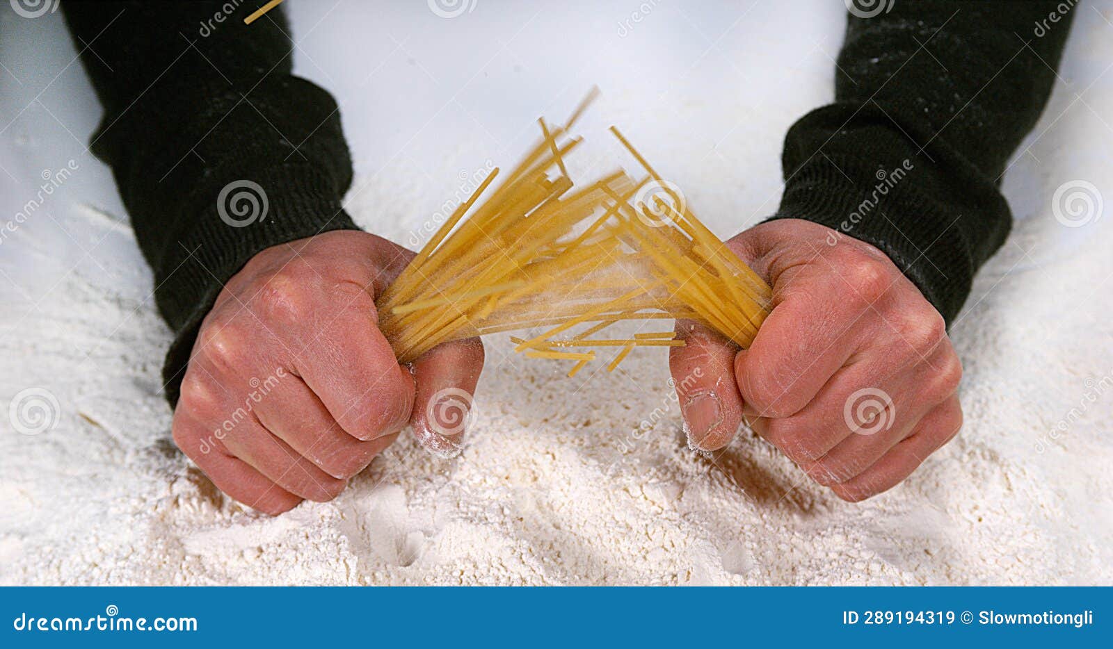 Hands of Man Breaking Spaghetti Pasta Against Flour Background Stock ...
