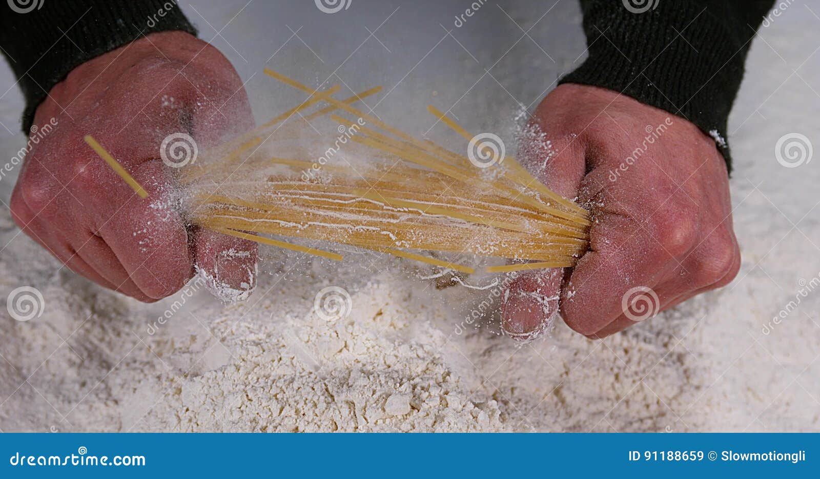 Hands of Man Breaking Spaghetti Pasta Against Flour Background, Stock ...