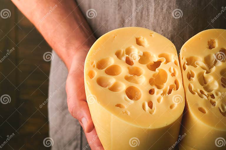 Hands of Man Hold Two Big Slices of Cheese Maasdam Against Background ... Hands of Man Hold Two Big Slices of Cheese Maasdam Against Background ...