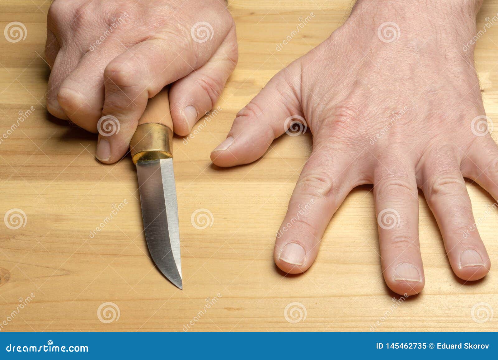 Hands of a Man with a Knife on a Wooden Table Stock Image - Image of ...
