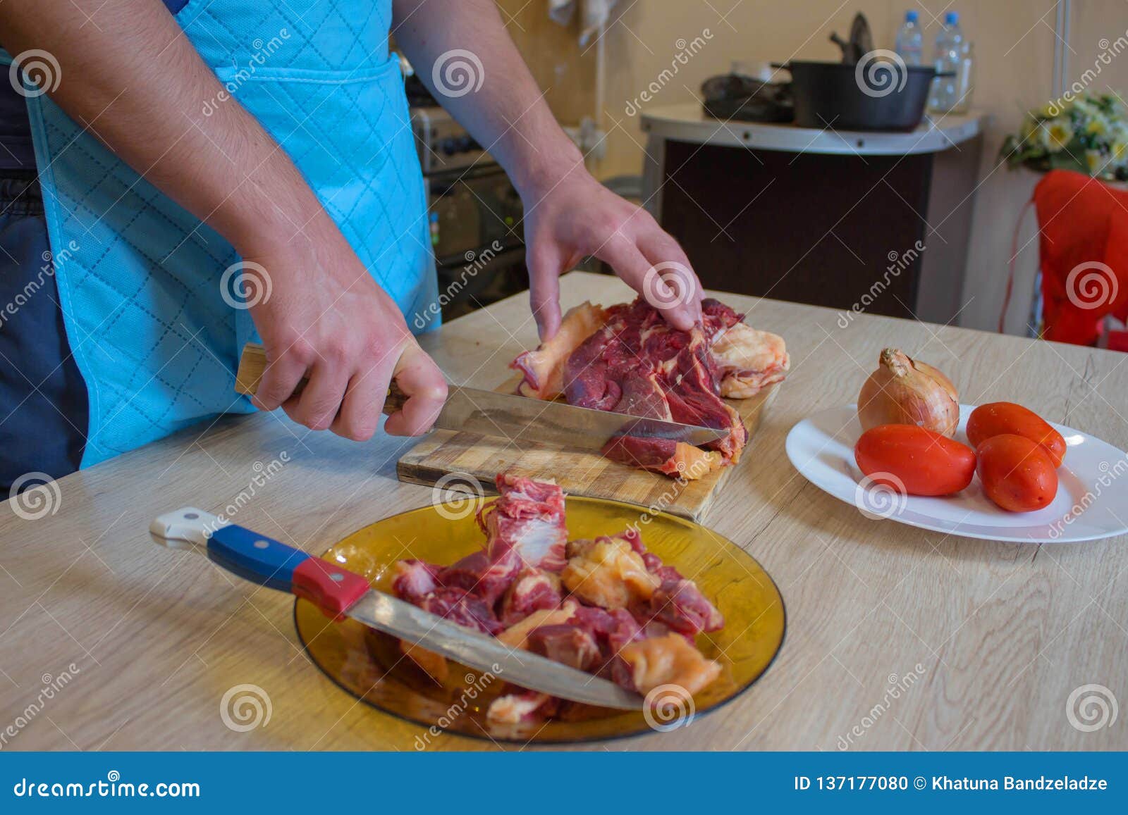 Hands of a Man Preparing Meat and Vegetables in a Kitchen. Focus on ...