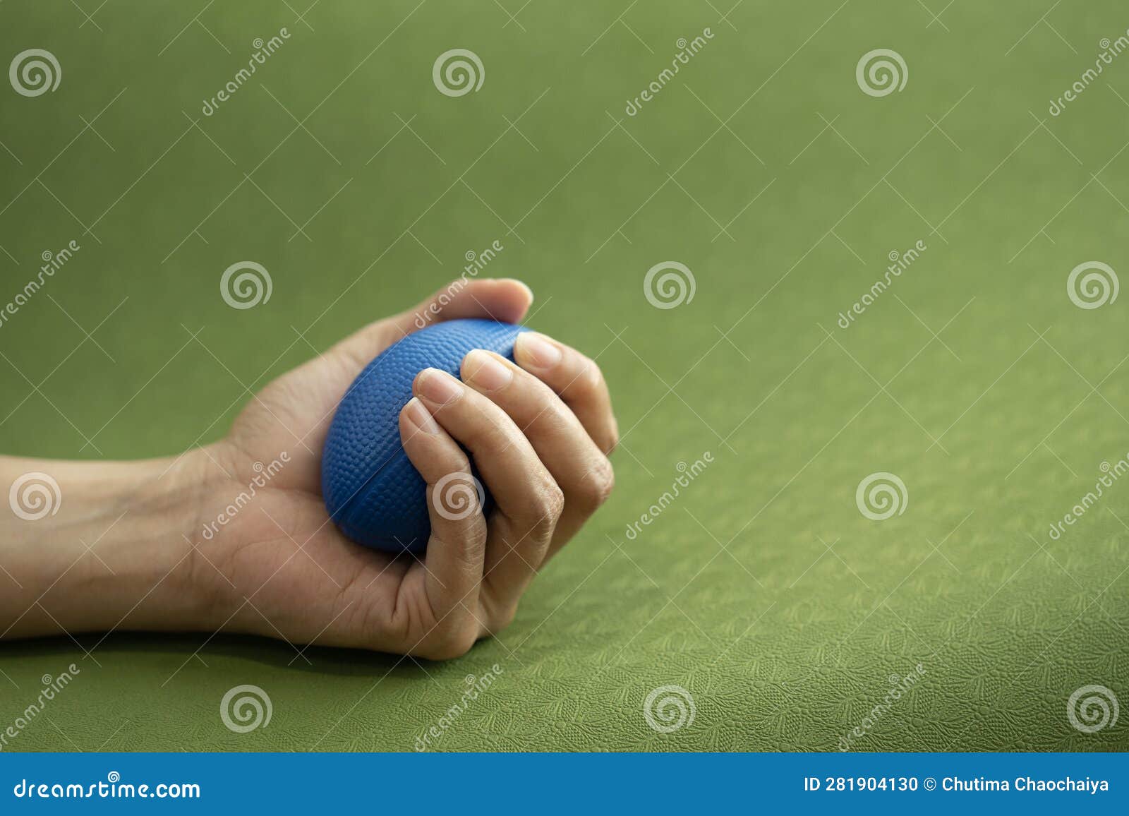 Hands of a Man Squeezing a Blue Stress Ball on the Yoga Mat Stock Photo ...