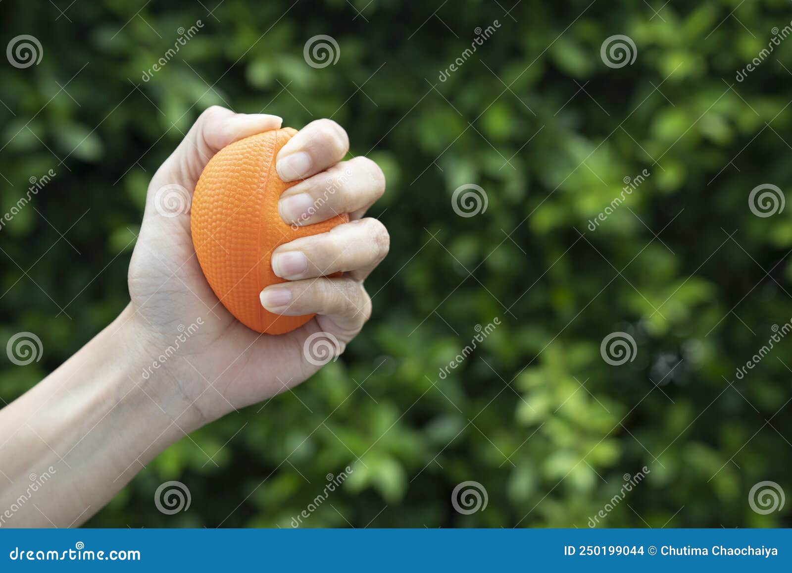 Hands of a Man Squeezing a Orange Stress Ball Stock Photo - Image of ...