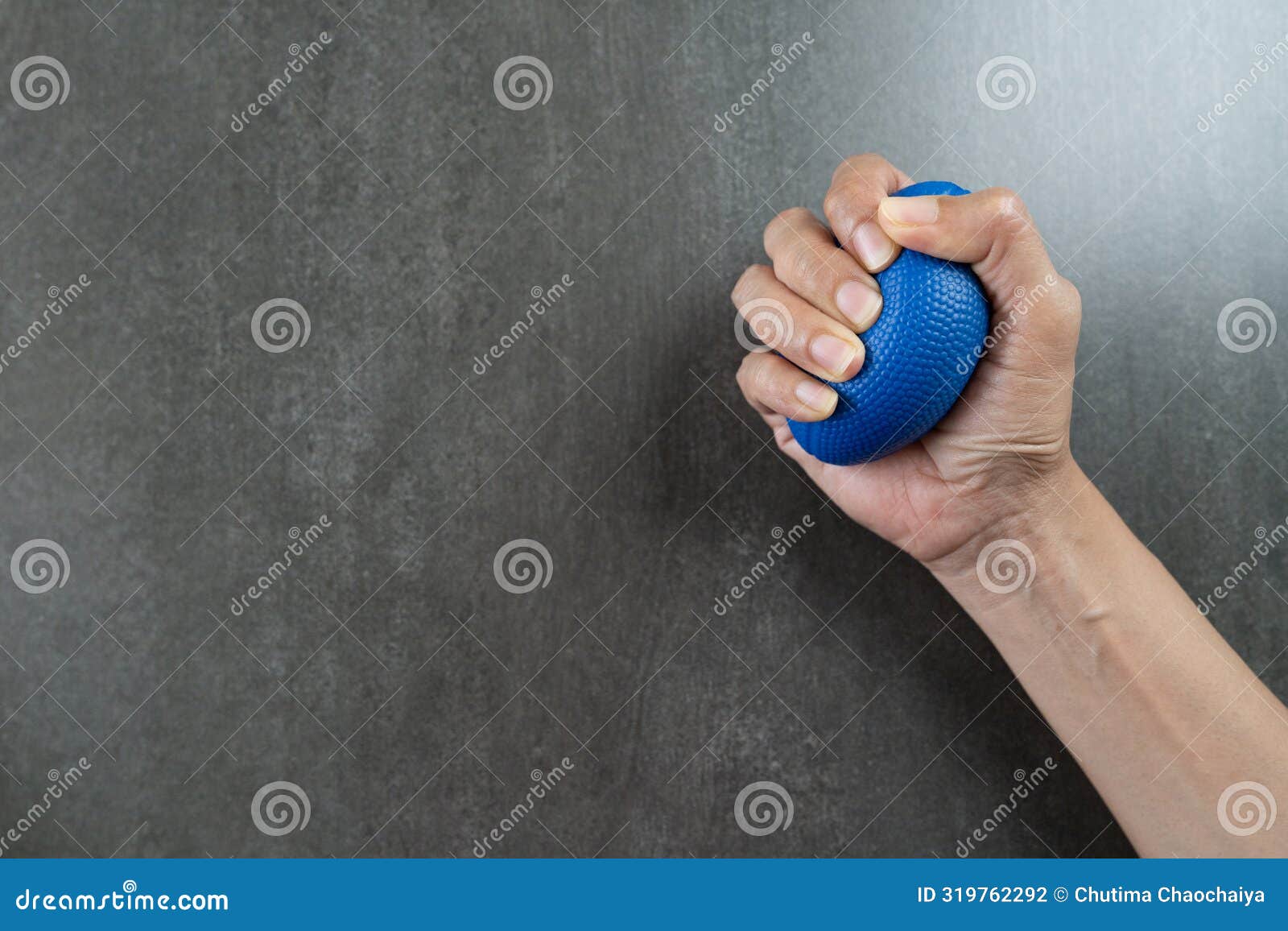 Hands of a Man Squeezing a Stress Ball on the Table in the Office Stock ...