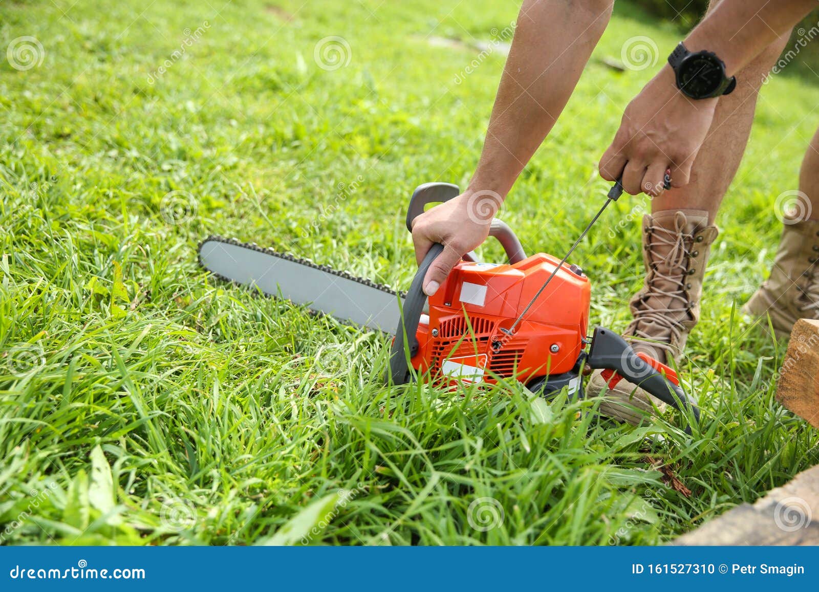Hands of a Man Start a Chainsaw. Stock Photo - Image of green, lawn ...