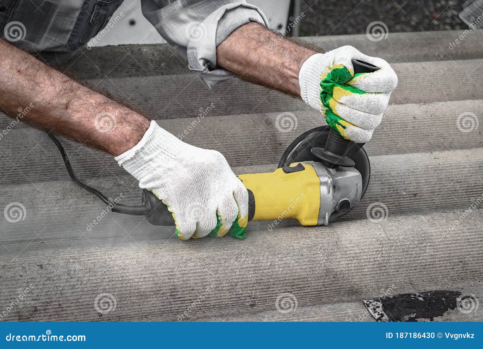 Hands of a Man with an Angle Grinder during Cutting of a Roofing ...