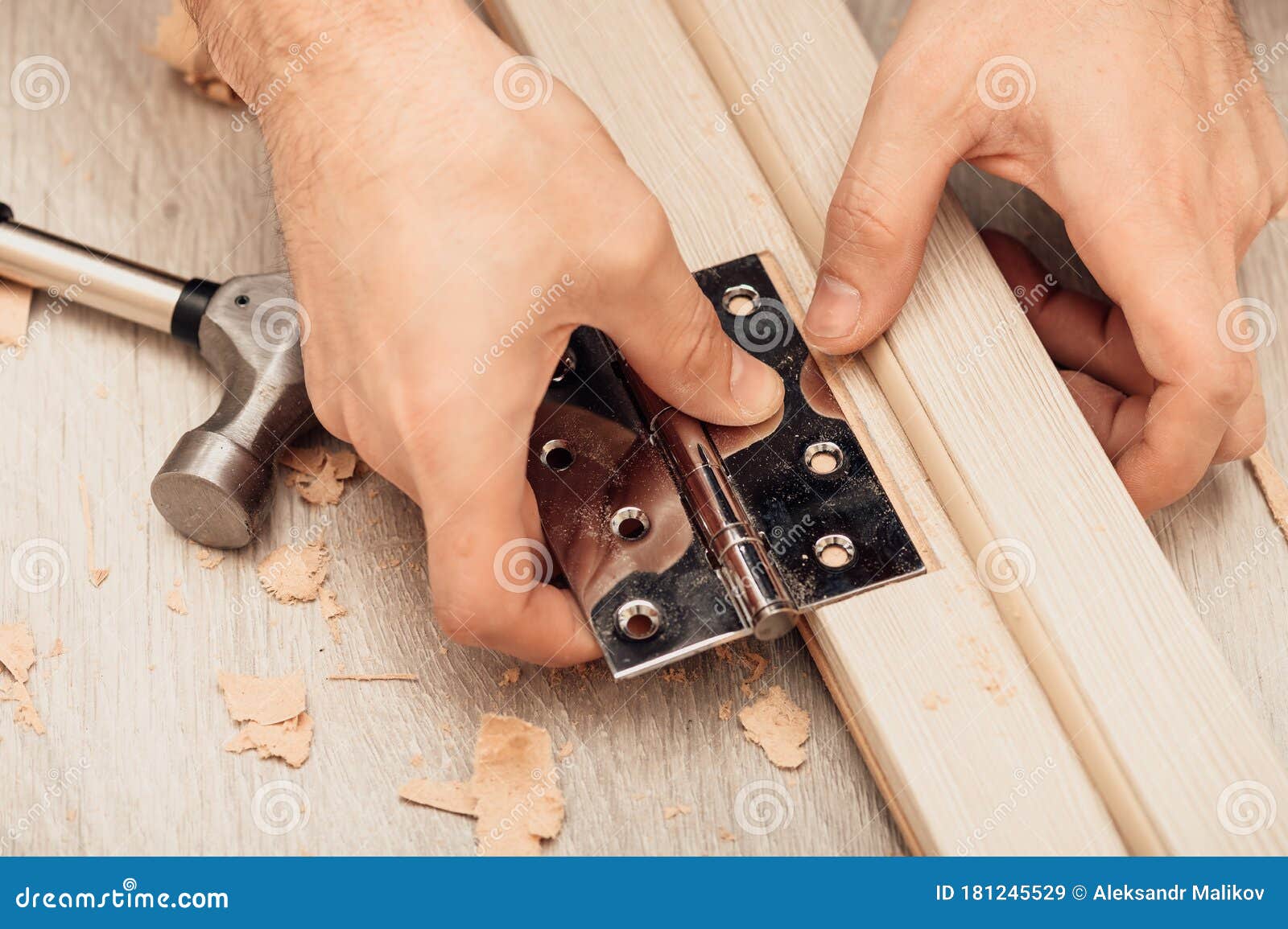 Hands of the Master Installing the Door Hinge with a Hand Tool, Close ...