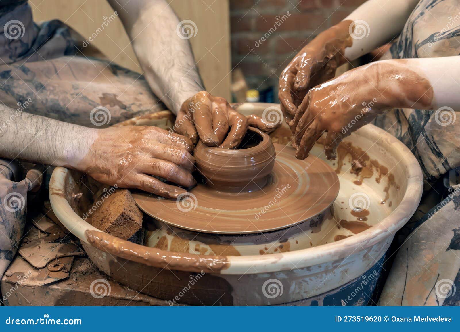 Hands of a Master Potter and a Child Making Dishes. a Lesson in a ...