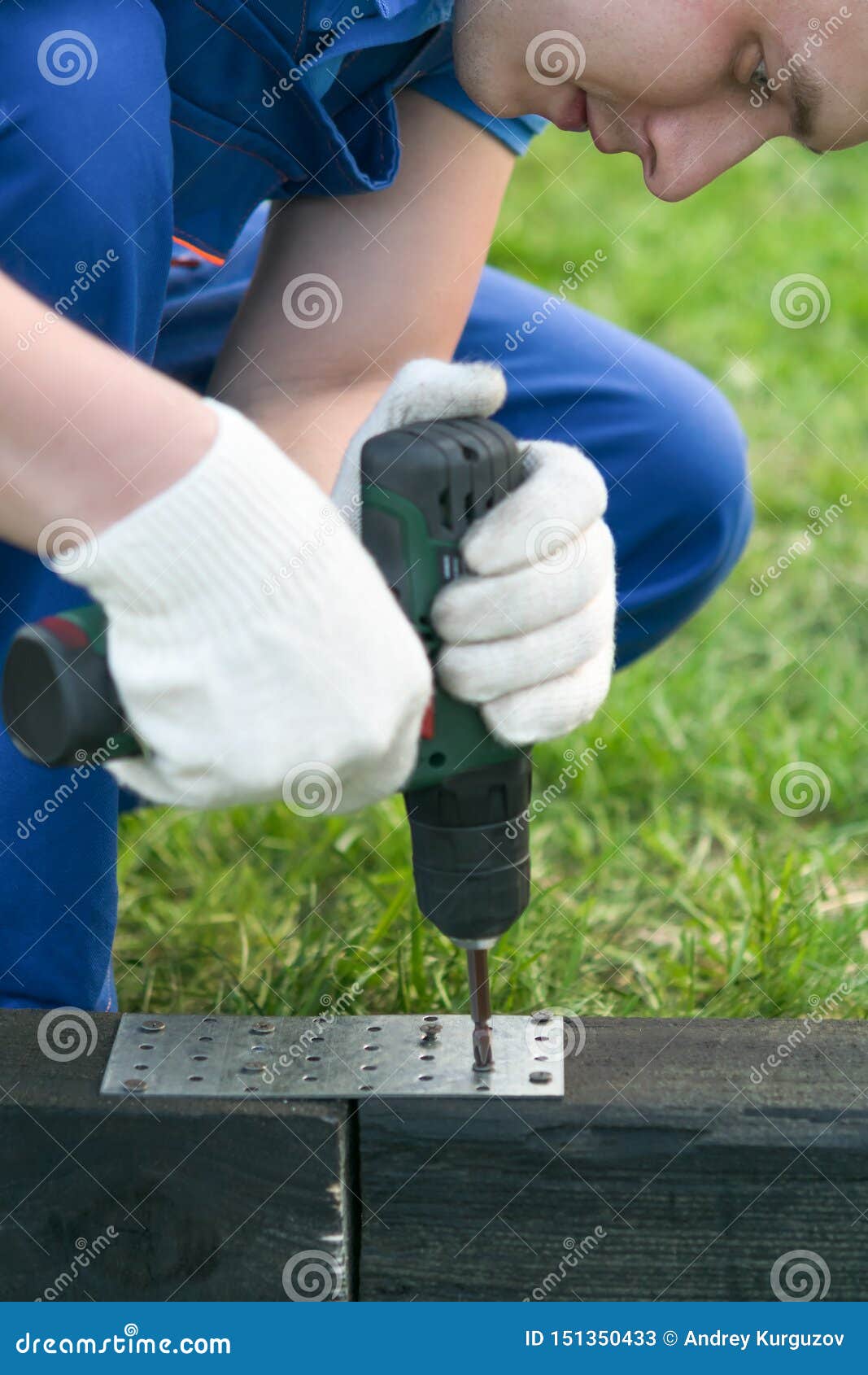 Hands of the Master Twist the into the Foundation with a Screwdriver ...