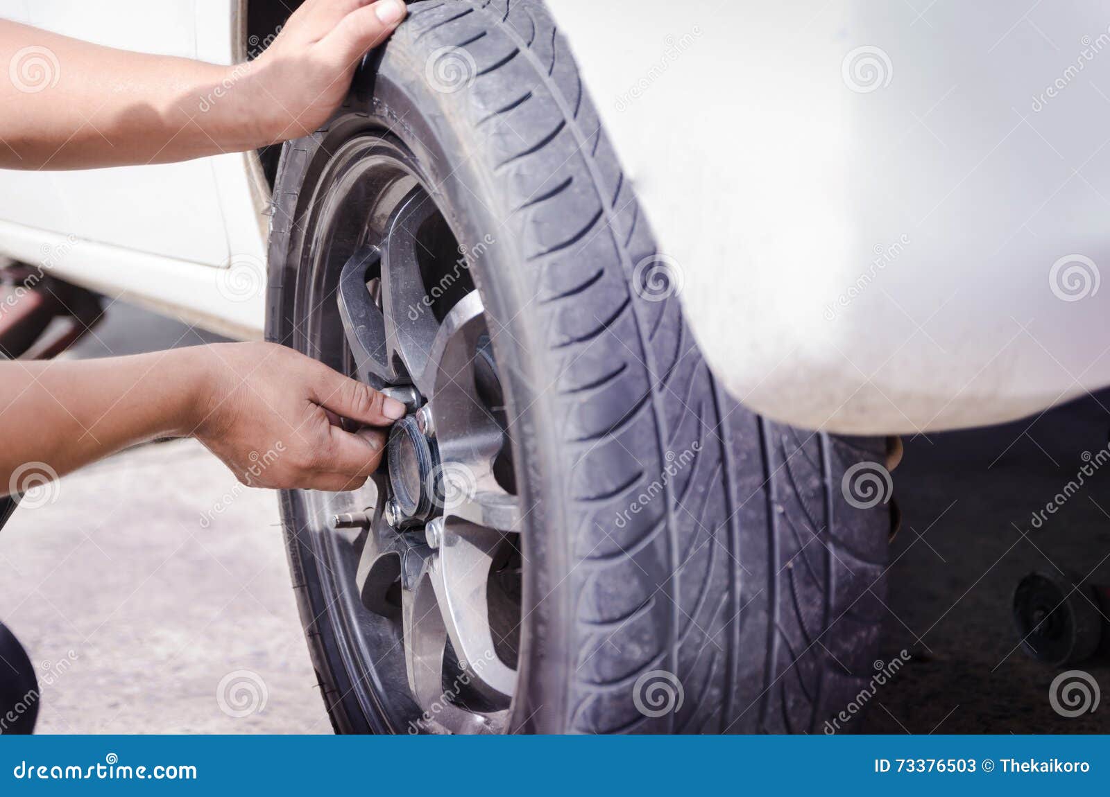 Hands of Mechanic Pick Up the Nut of Car Wheel and Tighten Stock Image ...