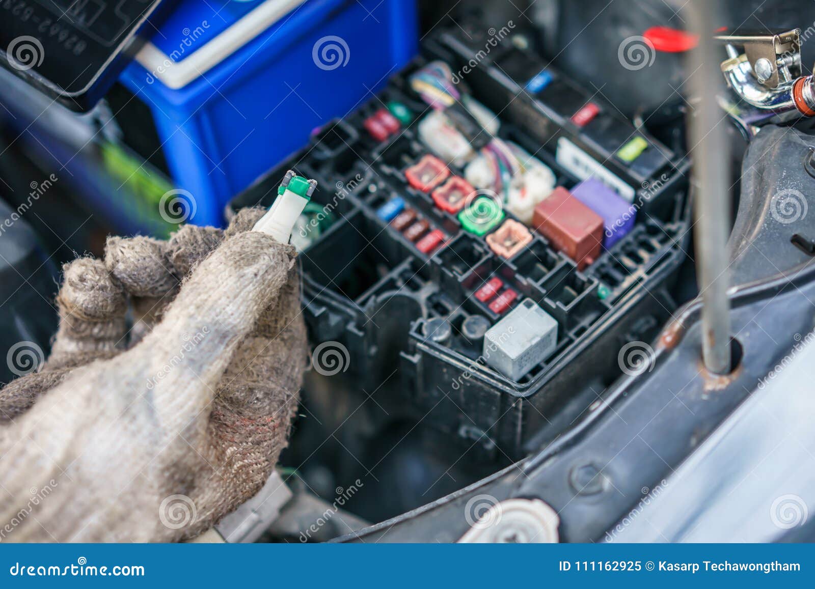 The Hands of the Mechanic Replacing the Fuse in the Car. the Mechanic ...
