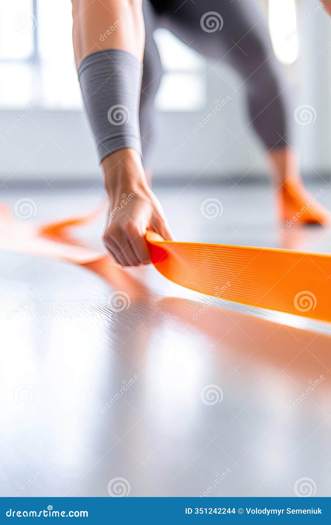 Hands in Motion Pulling a Resistance Band Against the Backdrop of a ...
