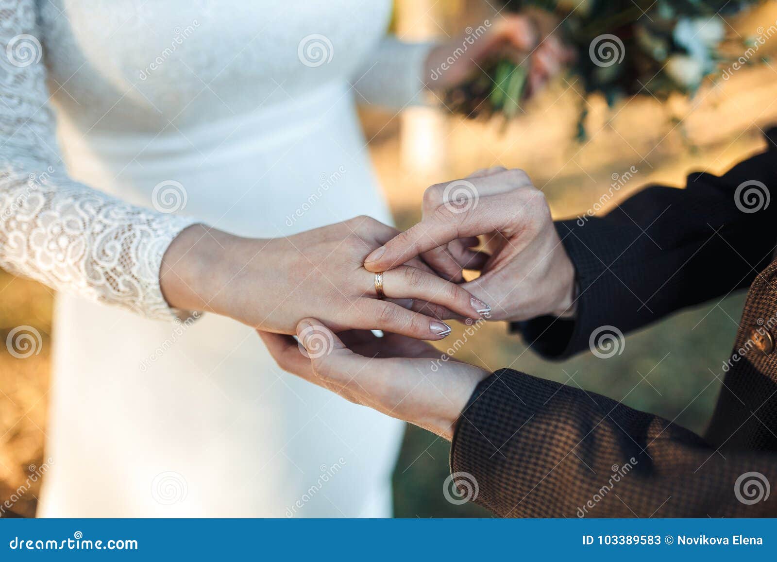 The Hands of the Newlyweds. a Man`s Hand Puts on a Ring. Wedding ...