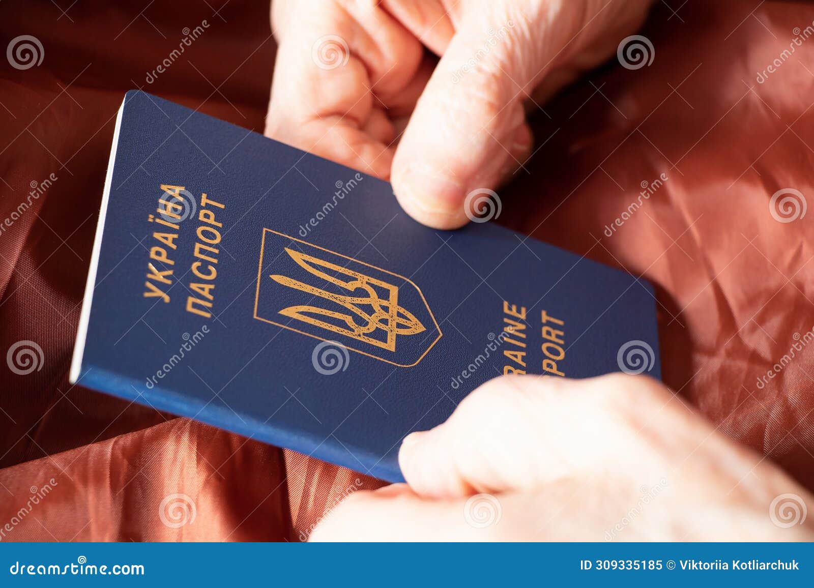 Hands Of An Old Woman Hold A Ukrainian Foreign Passport Ukrainian