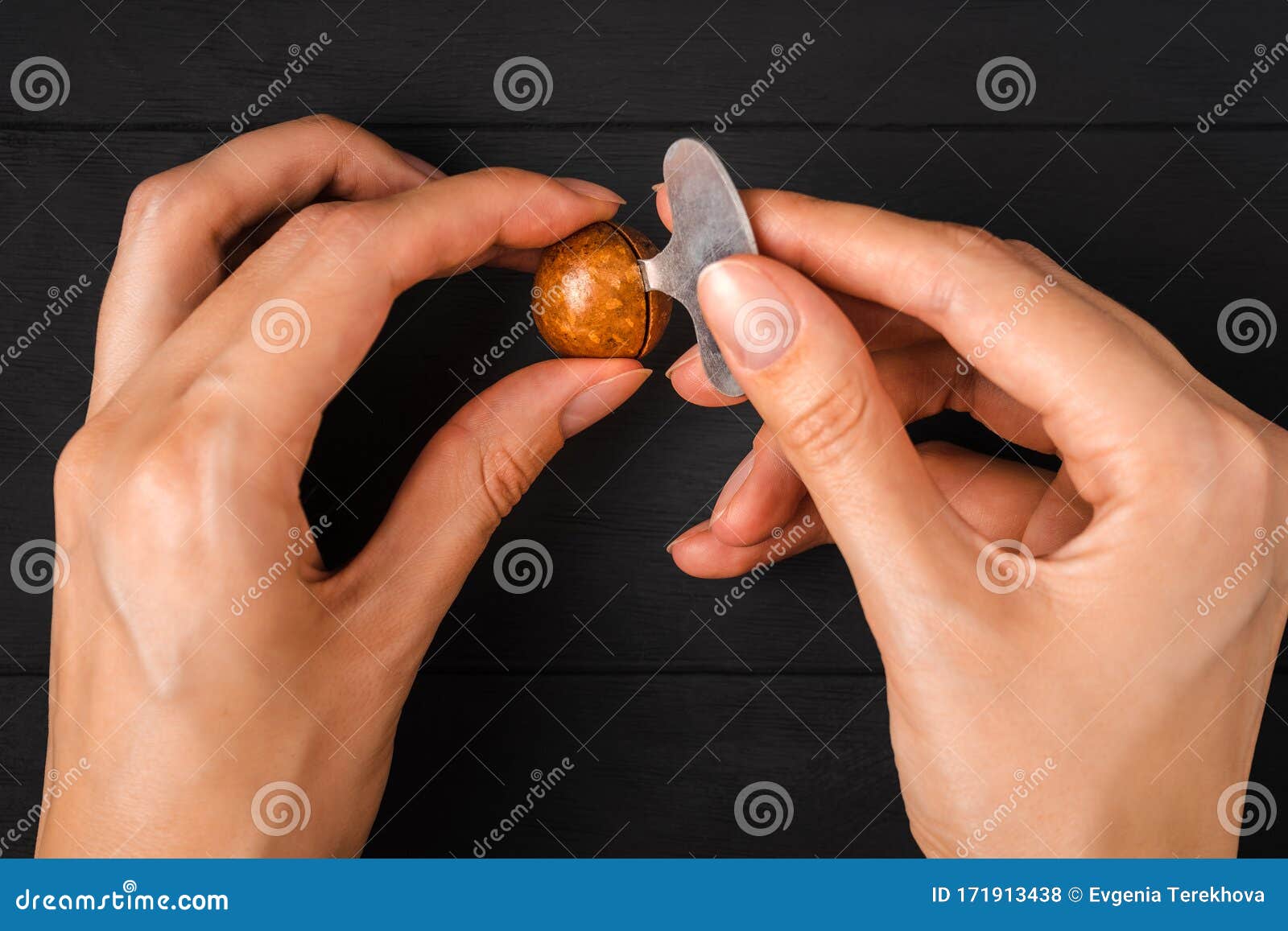 Hands Open the Macadamia Nut with a Special Key Stock Photo - Image of ...