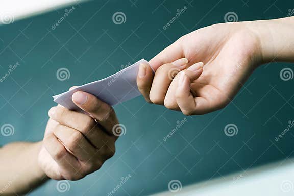 Hands passing a note stock image. Image of learning - 187989025