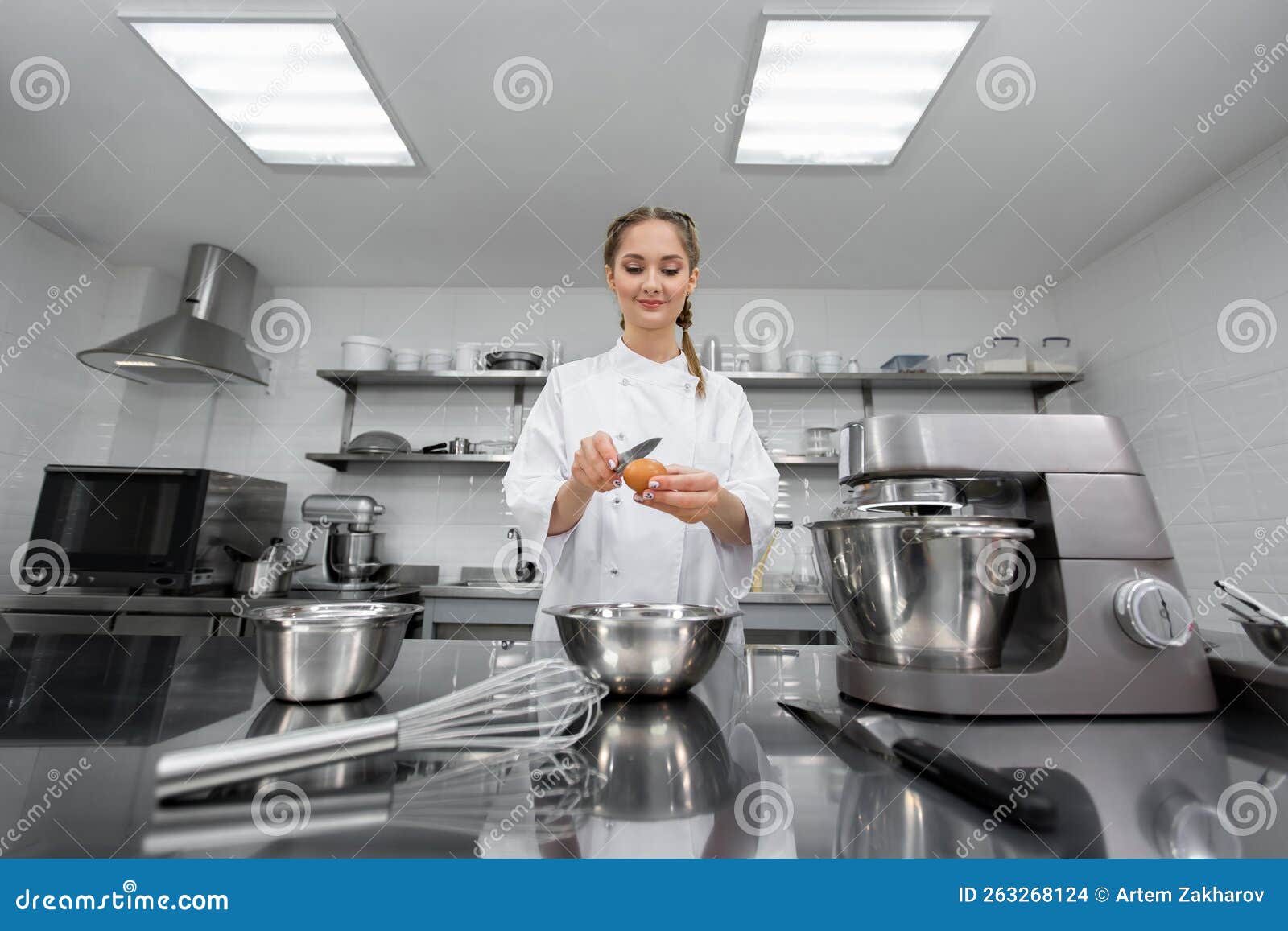 Hands of a Pastry Chef Break an Egg with a Knife in a Professional ...