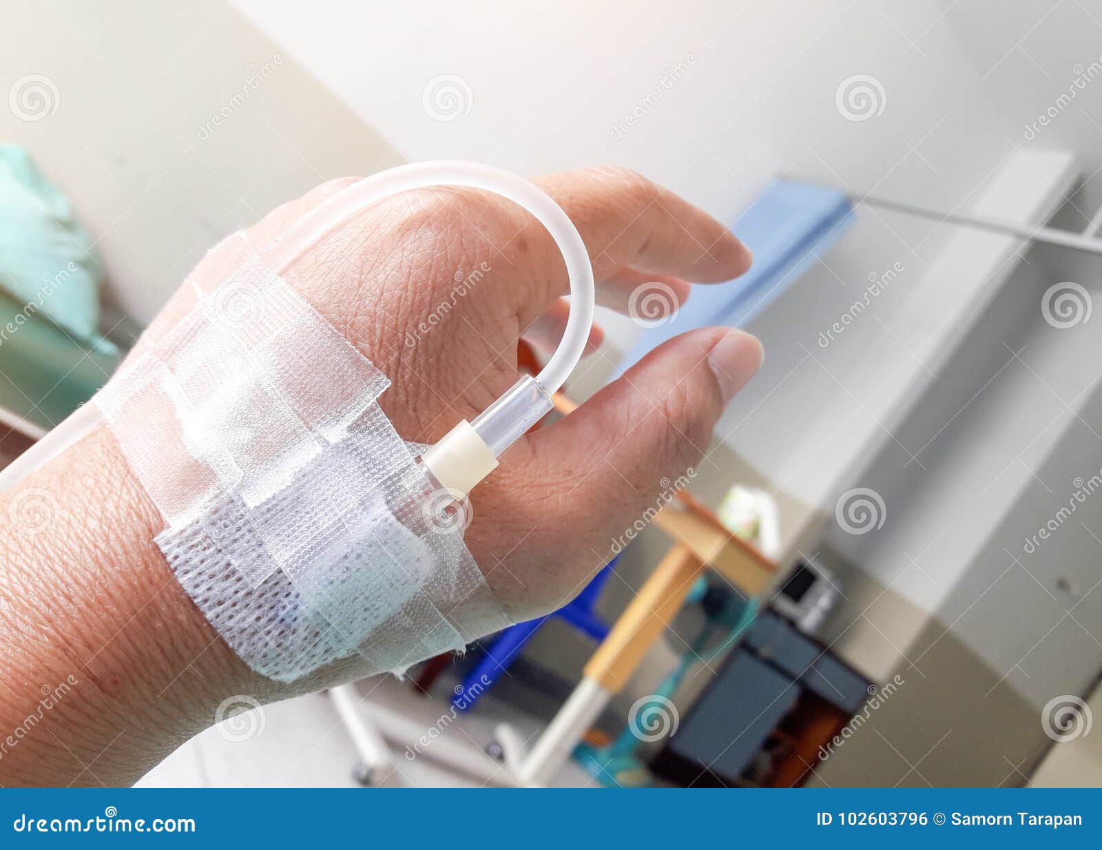 Hands of Patient is on Drip Receiving a Saline Solution on Bed I Stock ...
