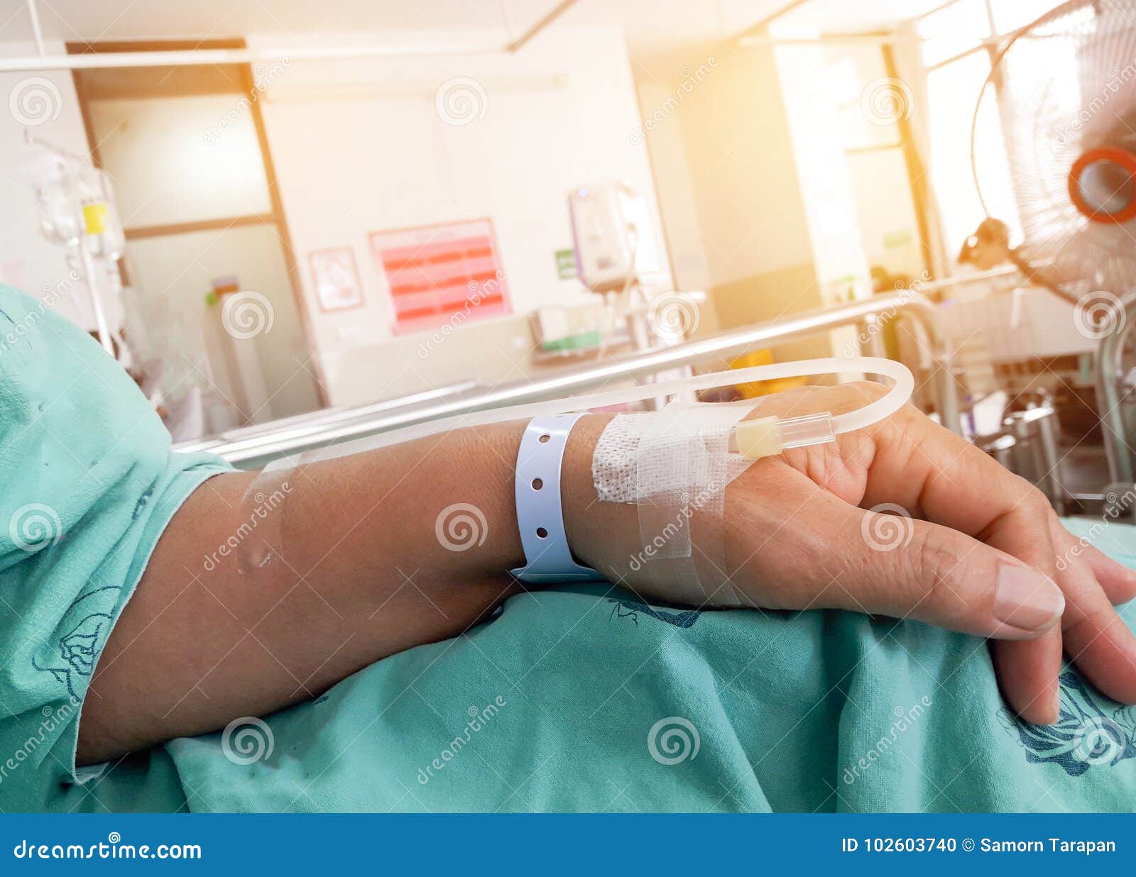 Hands of Patient is on Drip Receiving a Saline Solution on Bed I Stock ...