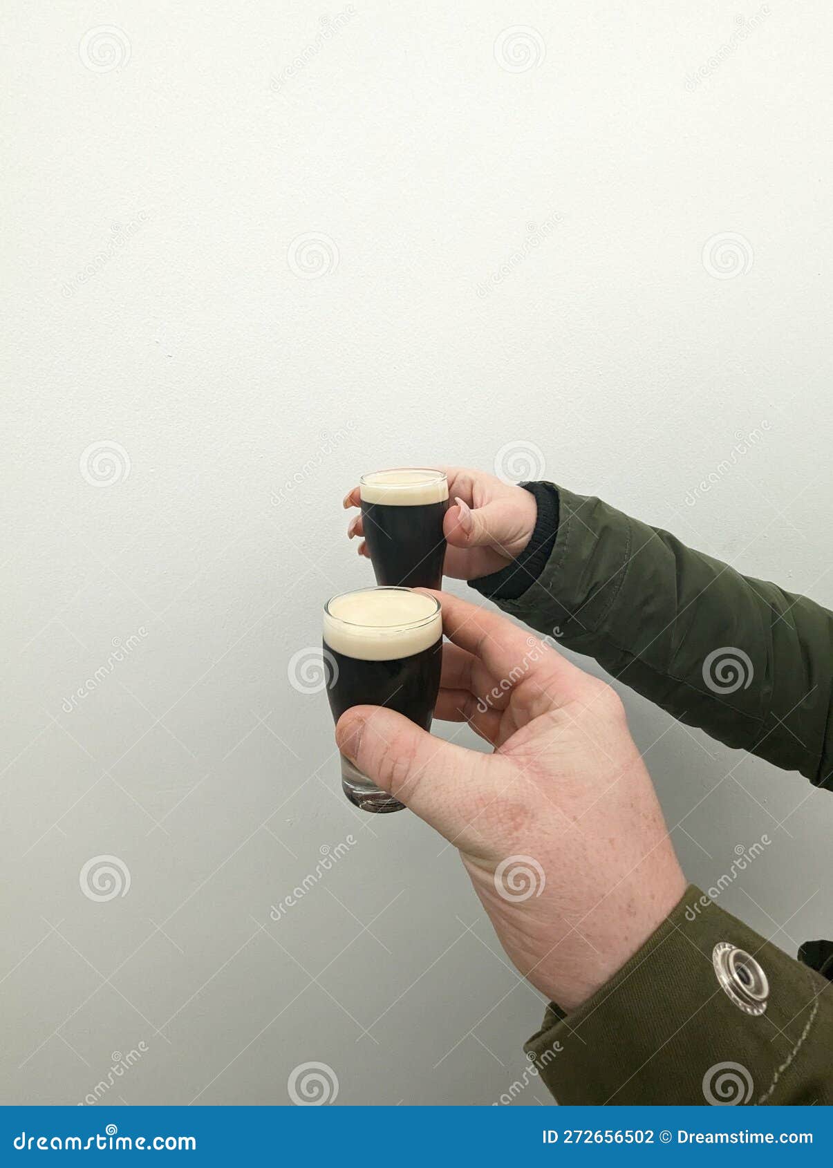 Hands of People Holding Two Shots on the White Background Stock Photo ...